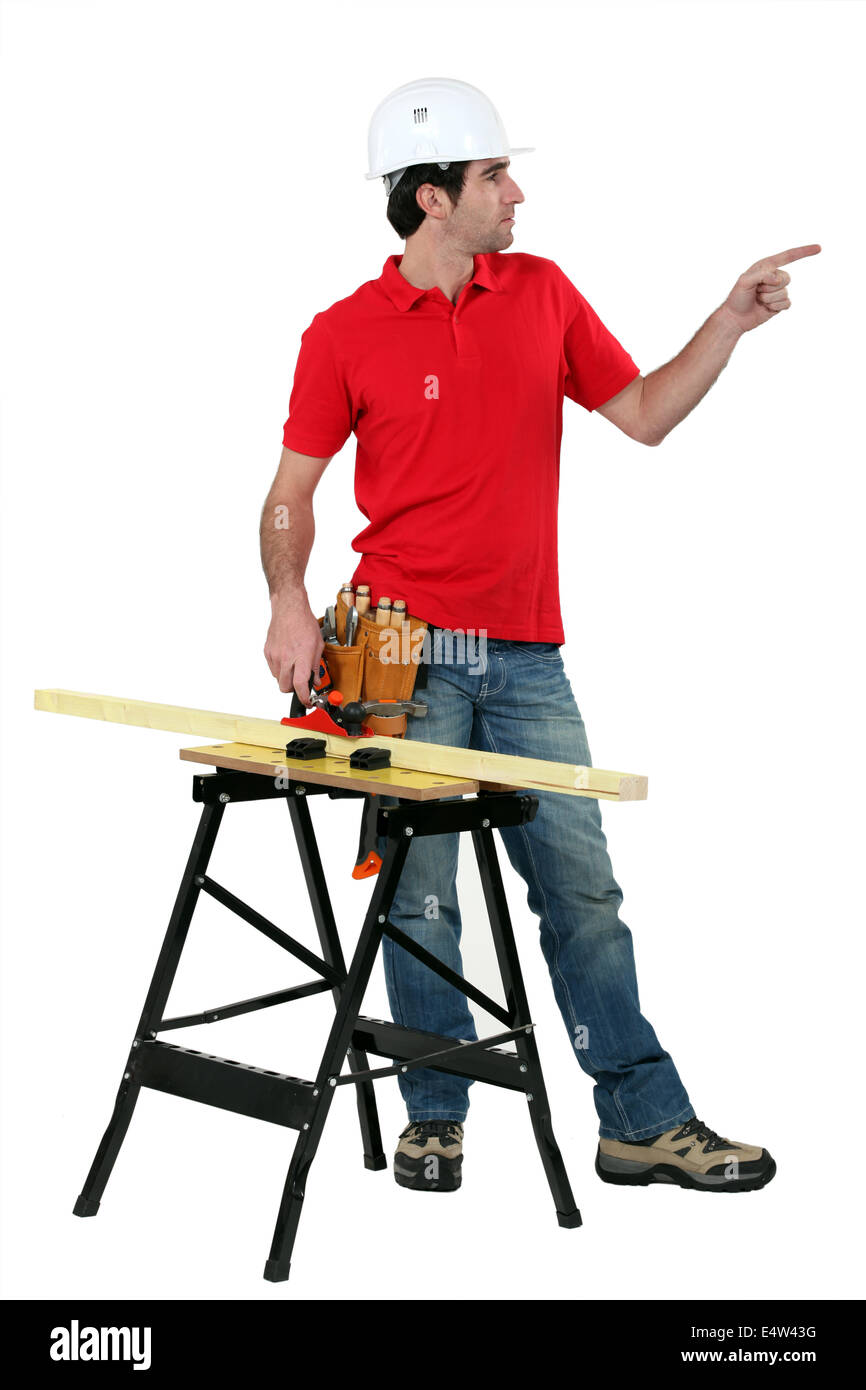 Carpenter pointing to empty copyspace Stock Photo - Alamy
