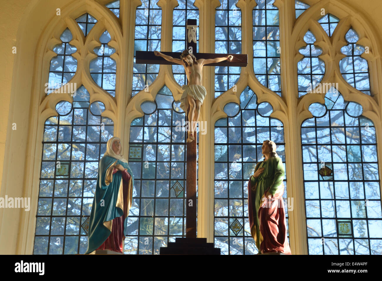 Cross and figures inside church Stock Photo - Alamy
