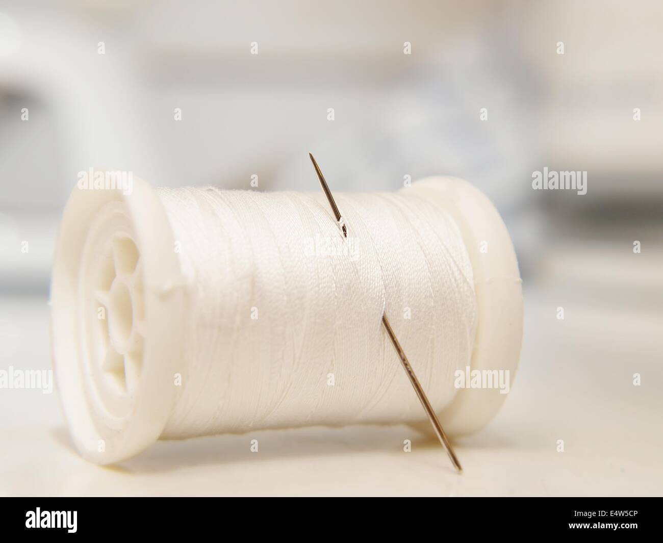 White thread on spool Stock Photo - Alamy