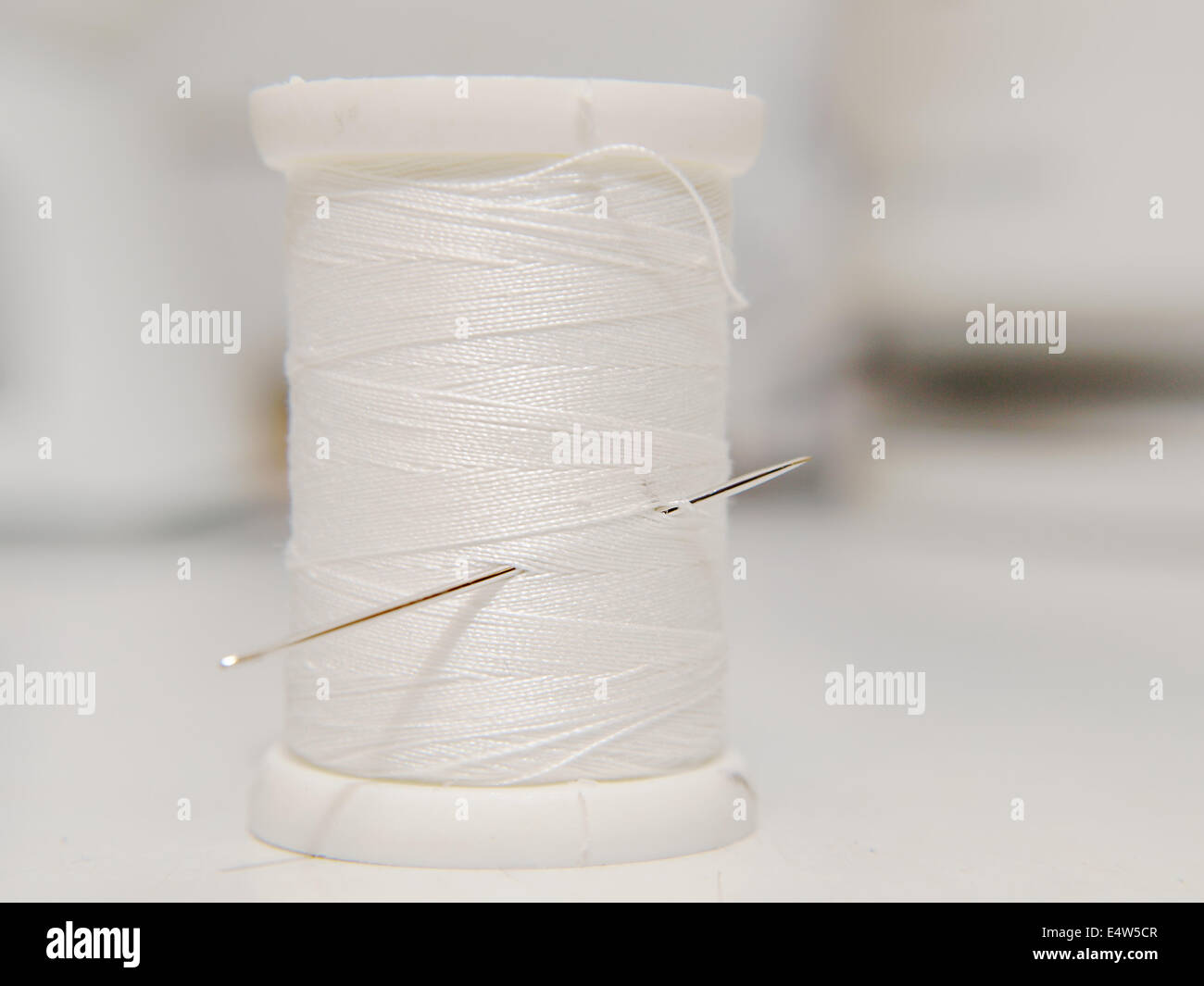 White thread on spool Stock Photo - Alamy
