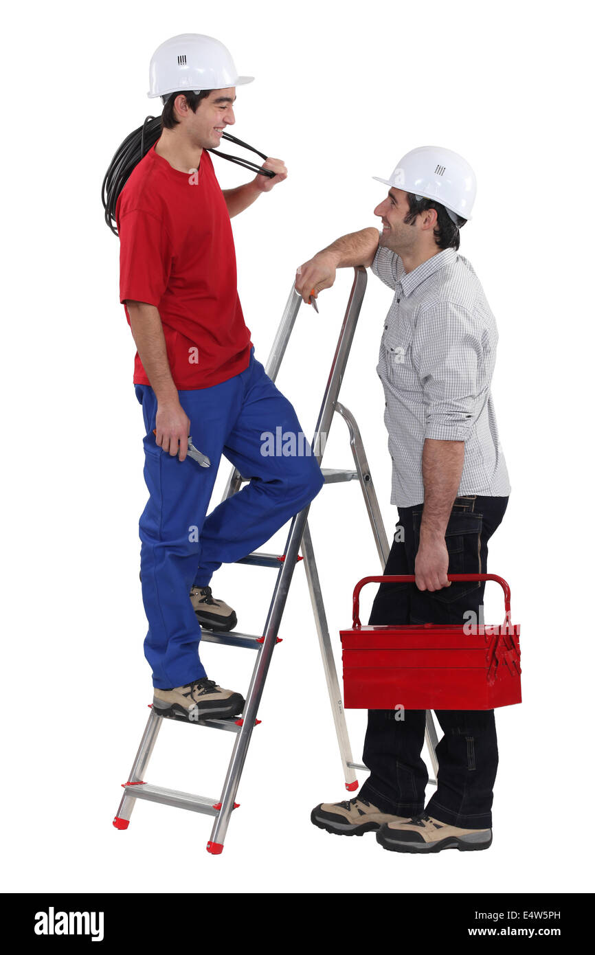 Two electricians having at chat at work Stock Photo - Alamy