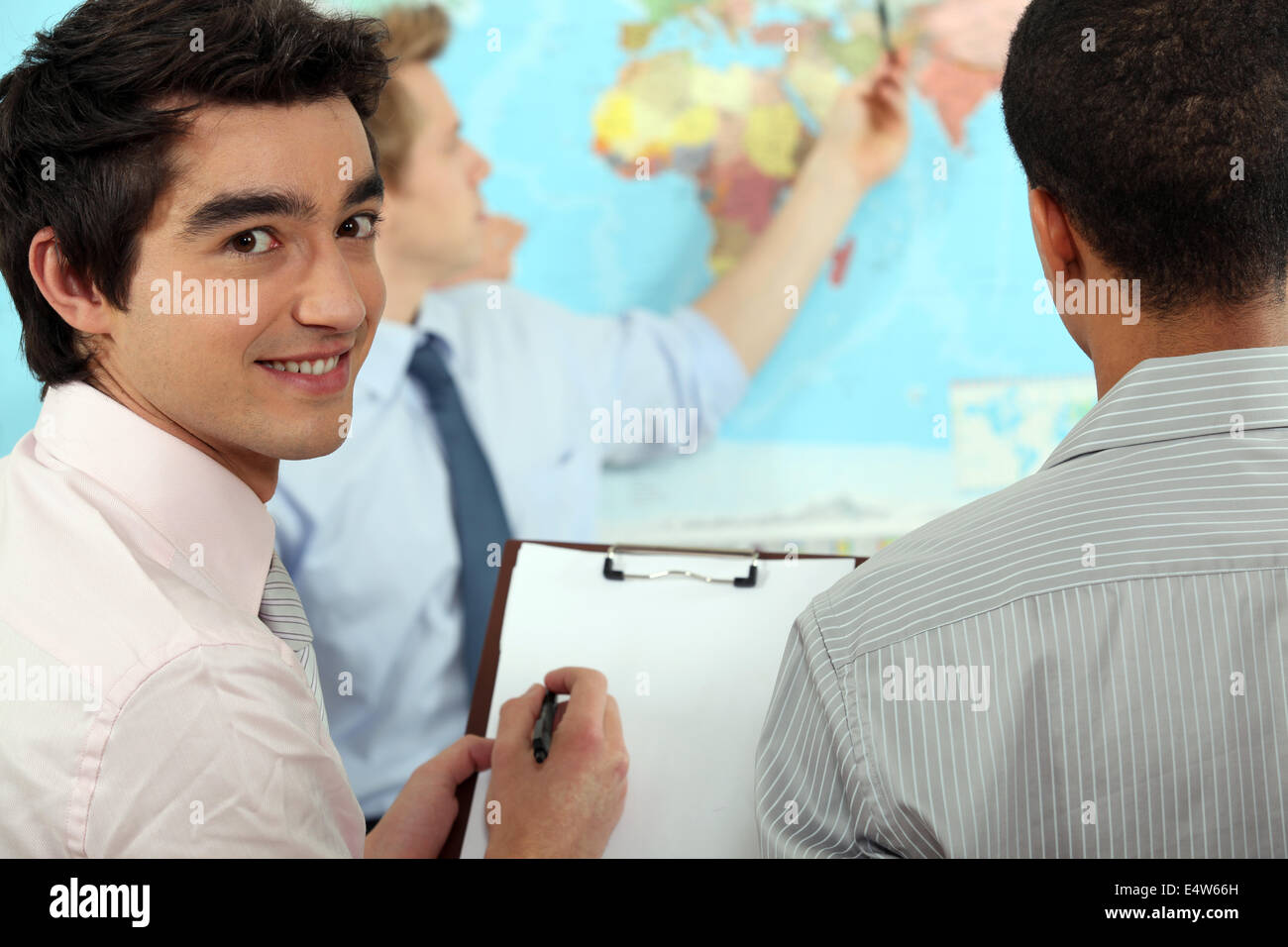 Business people discussing world map hi-res stock photography and ...