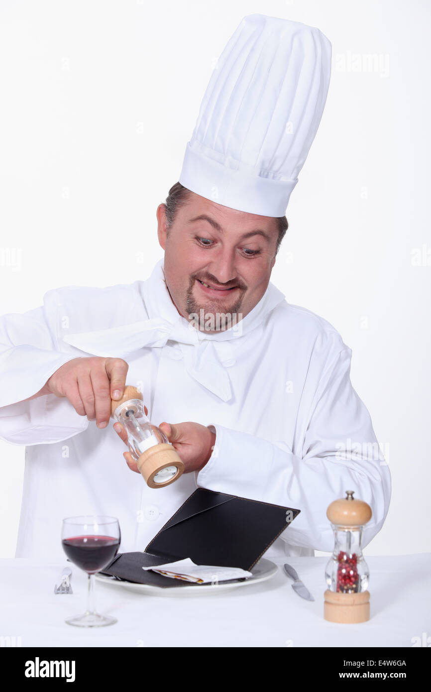 Chef seasoning the bill Stock Photo - Alamy