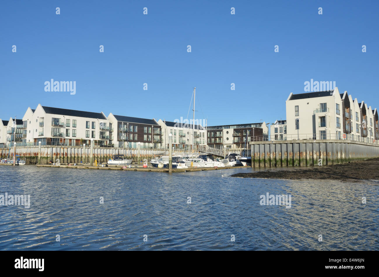 Small marina with sea in foreground Stock Photo - Alamy