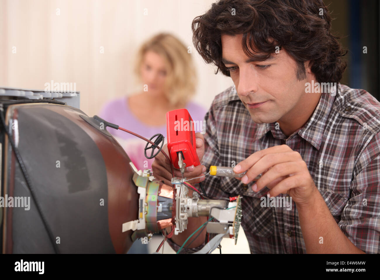 Woman fixing television hi-res stock photography and images - Alamy