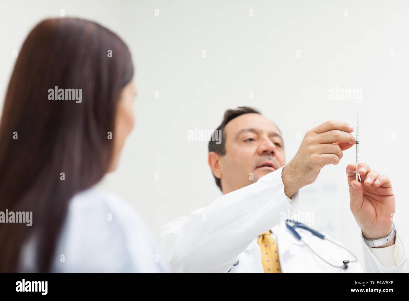 Doctor checking an injection for a patient Stock Photo - Alamy