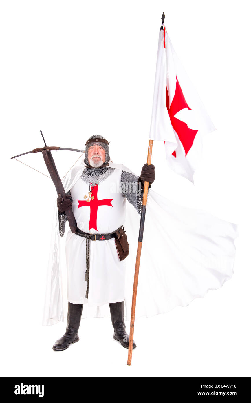 Knight Templar posing with crossbow and flag isolated in white Stock ...