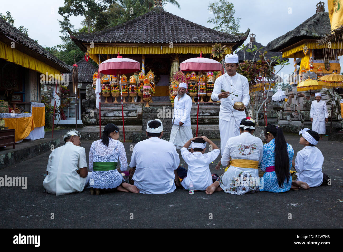Bali, Indonesia. Hindu Priest Blessing Worshipers with Holy Water. Pura ...