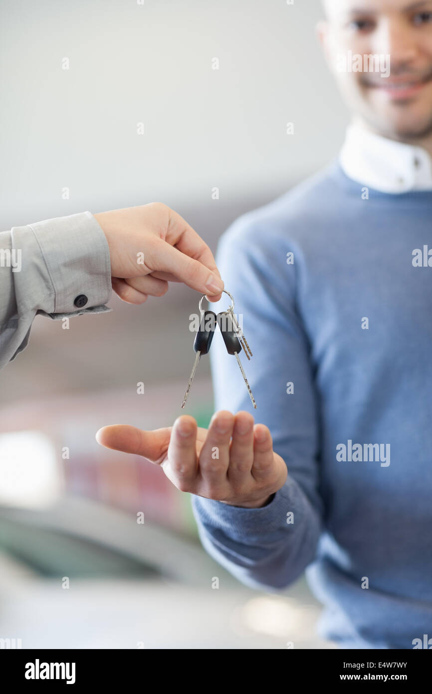 Customer receiving keys from a car dealer Stock Photo - Alamy