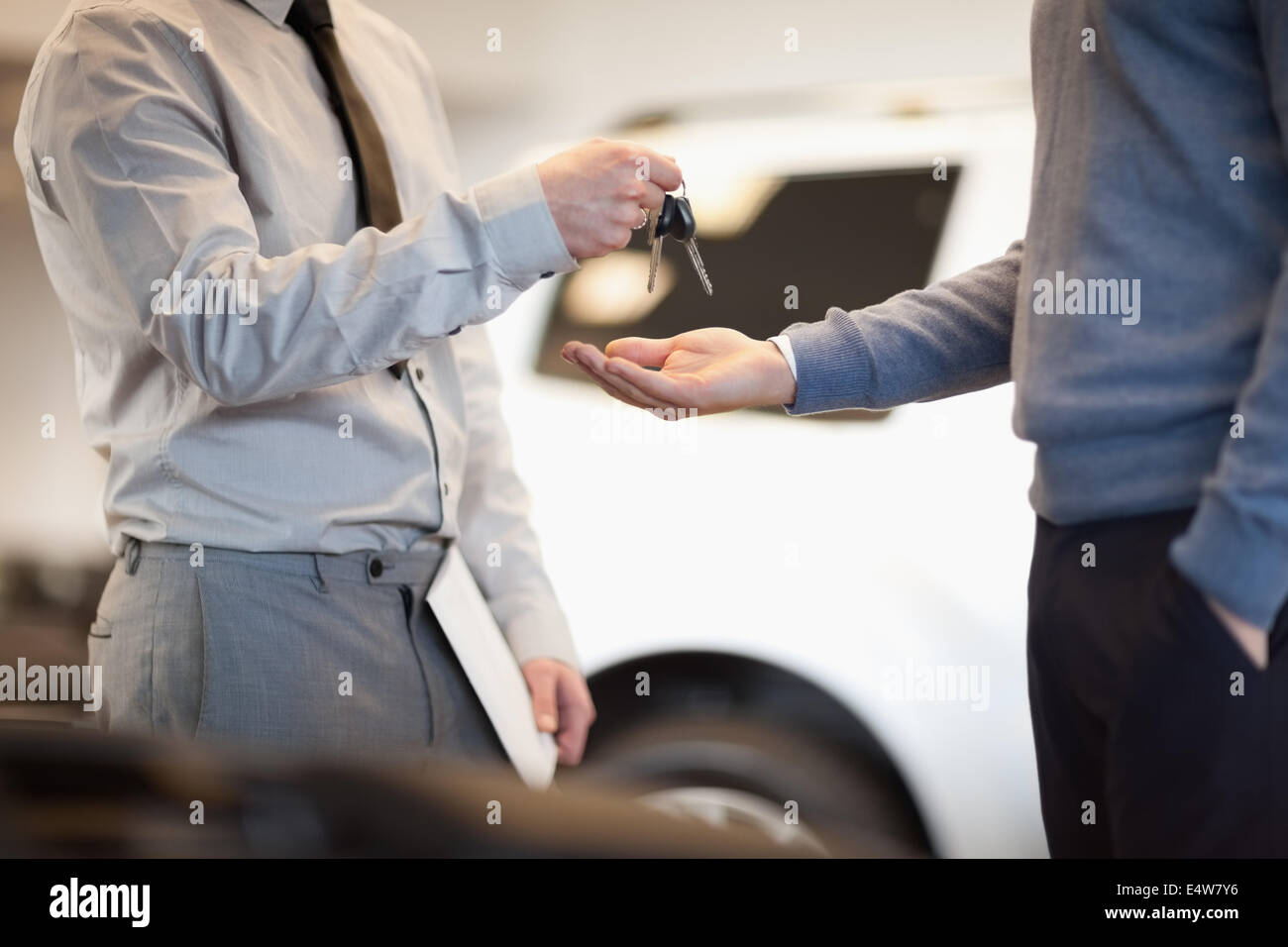 Man giving keys to another man Stock Photo - Alamy