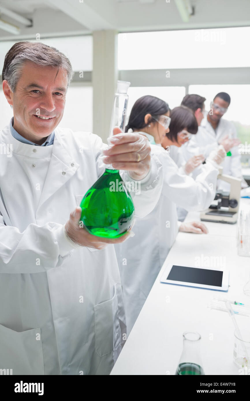 Chemist holding beaker Stock Photo - Alamy
