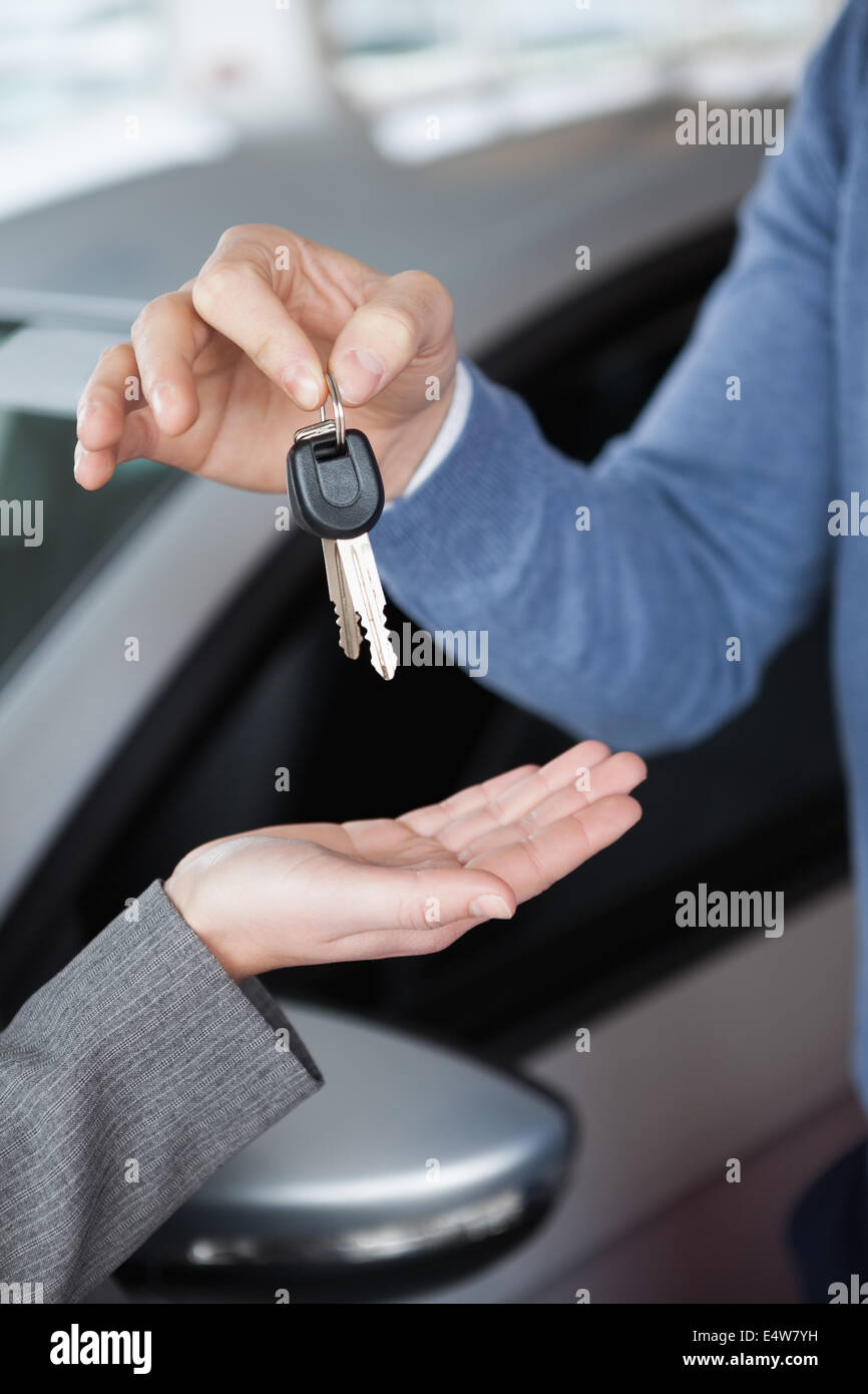 Man giving keys to a woman Stock Photo - Alamy