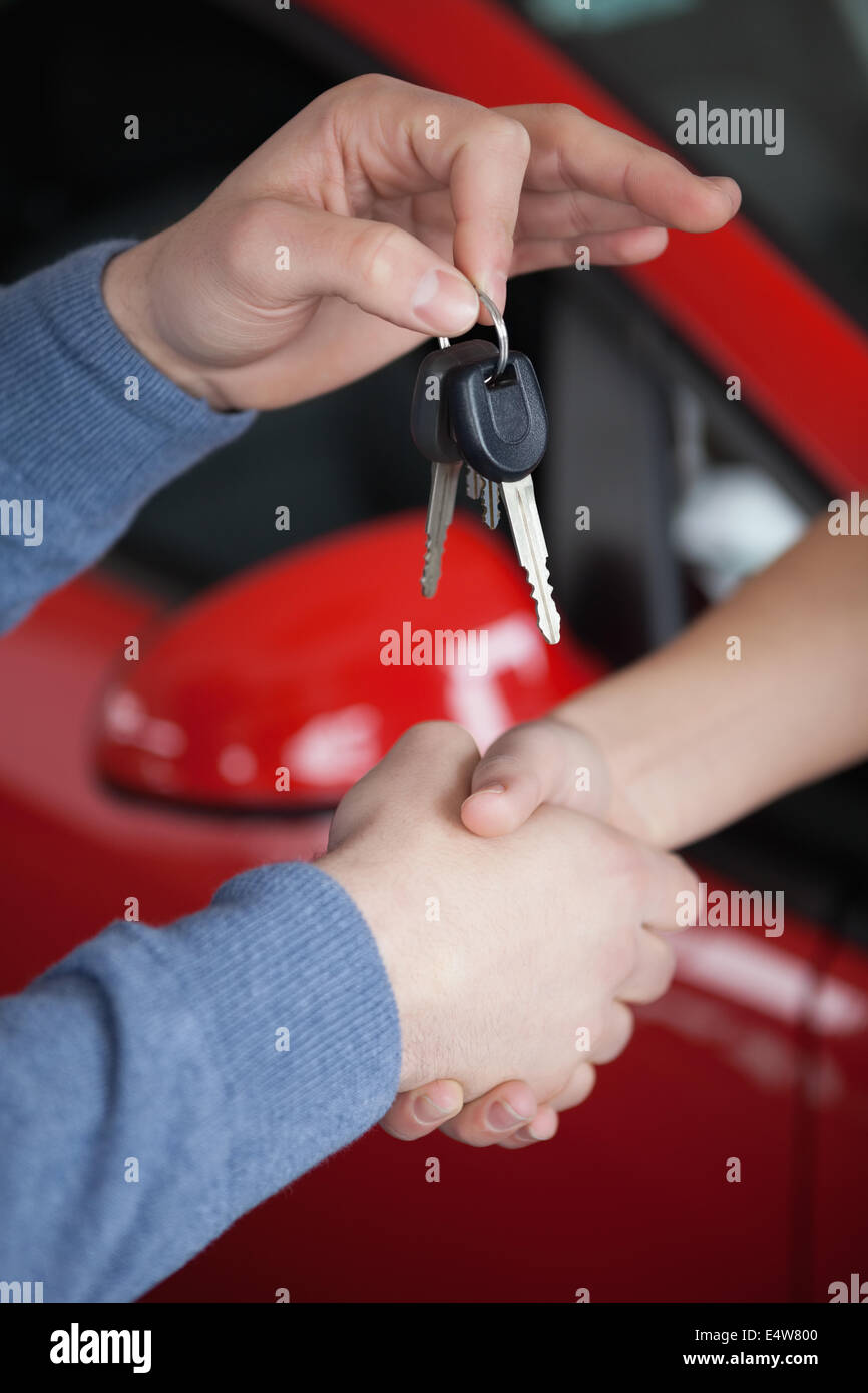 Hands shaking and keys being hold Stock Photo - Alamy
