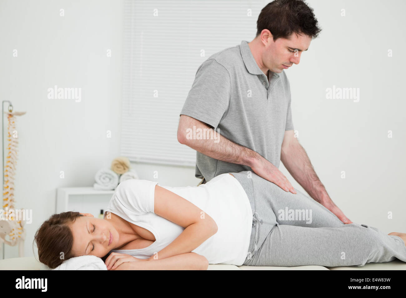 Doctor looking at the thigh of his patient Stock Photo - Alamy