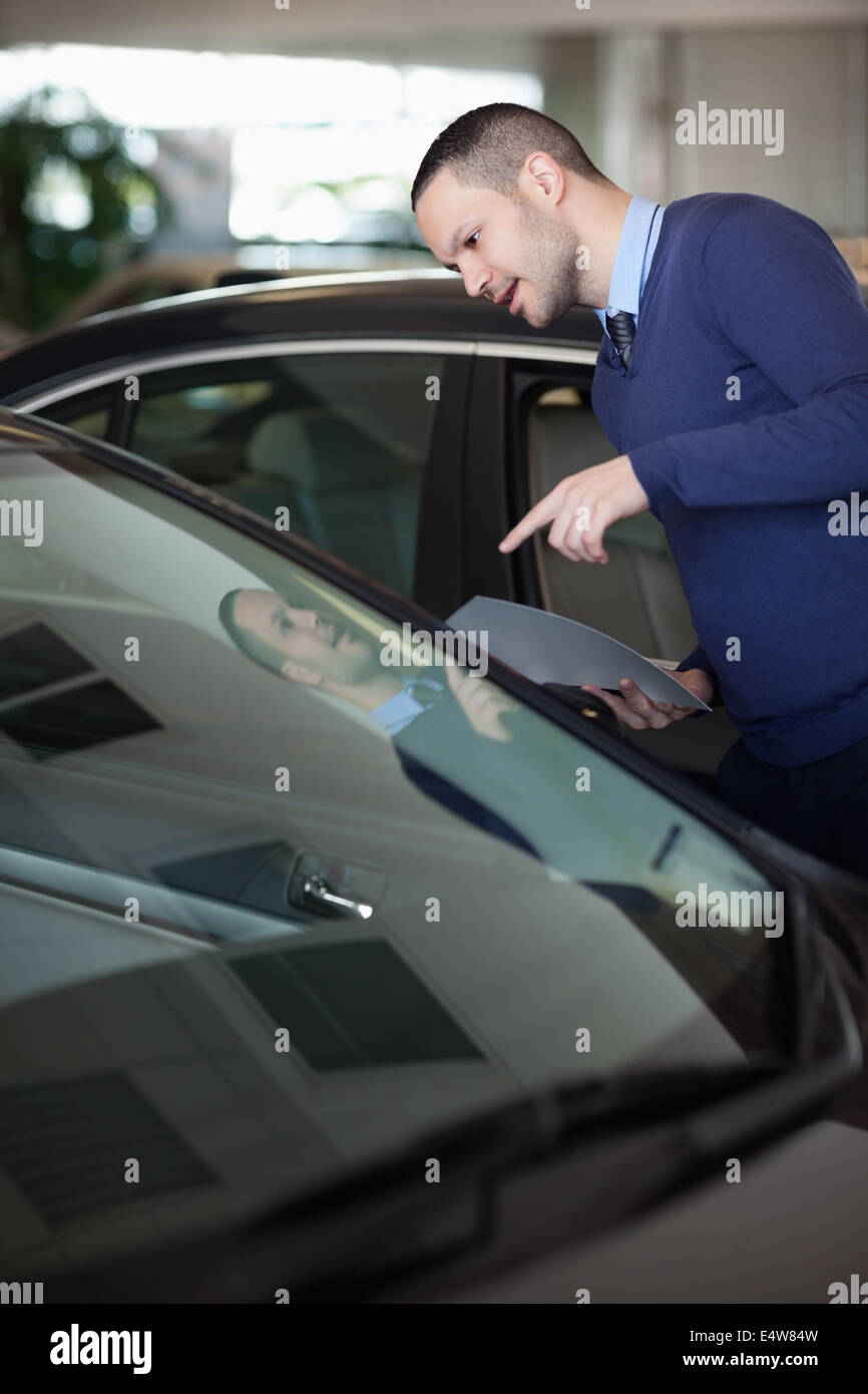 Man looking inside a car Stock Photo - Alamy