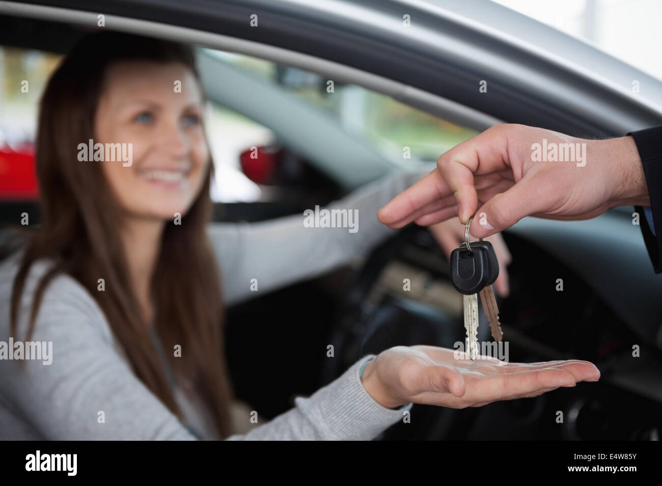 Happy woman receiving car keys Stock Photo - Alamy