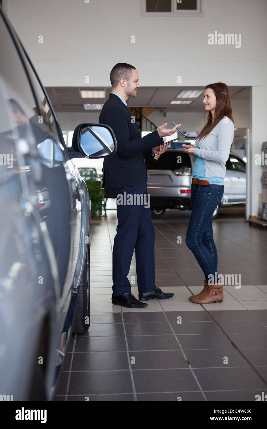 Client speaking with a salesman Stock Photo - Alamy