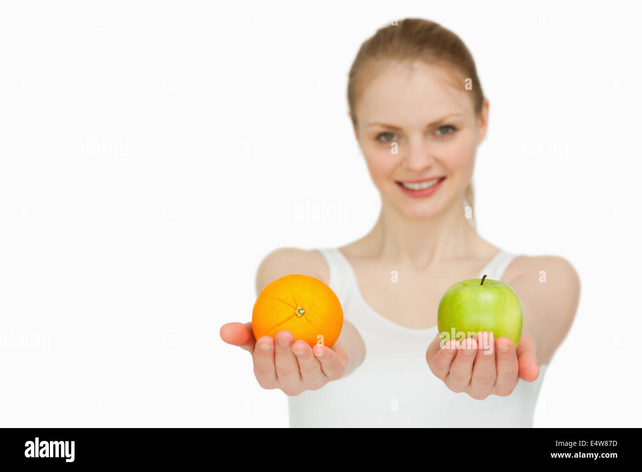 Young smiling woman presenting fruits Stock Photo - Alamy