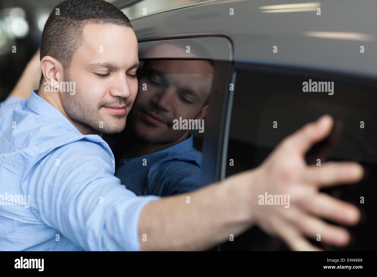 Man hugging on a car Stock Photo - Alamy