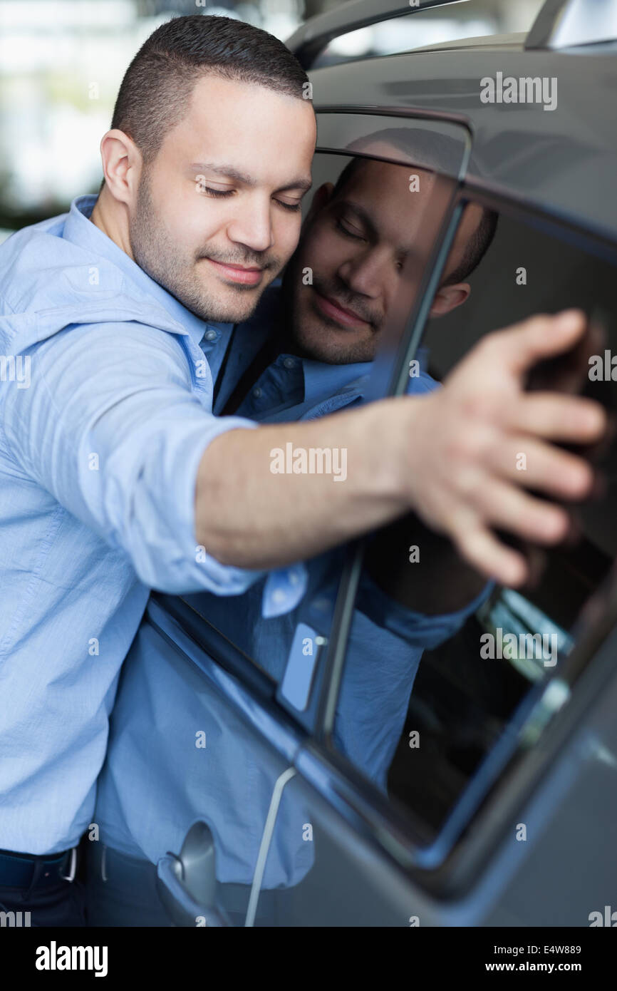 Man hugging a car Stock Photo - Alamy