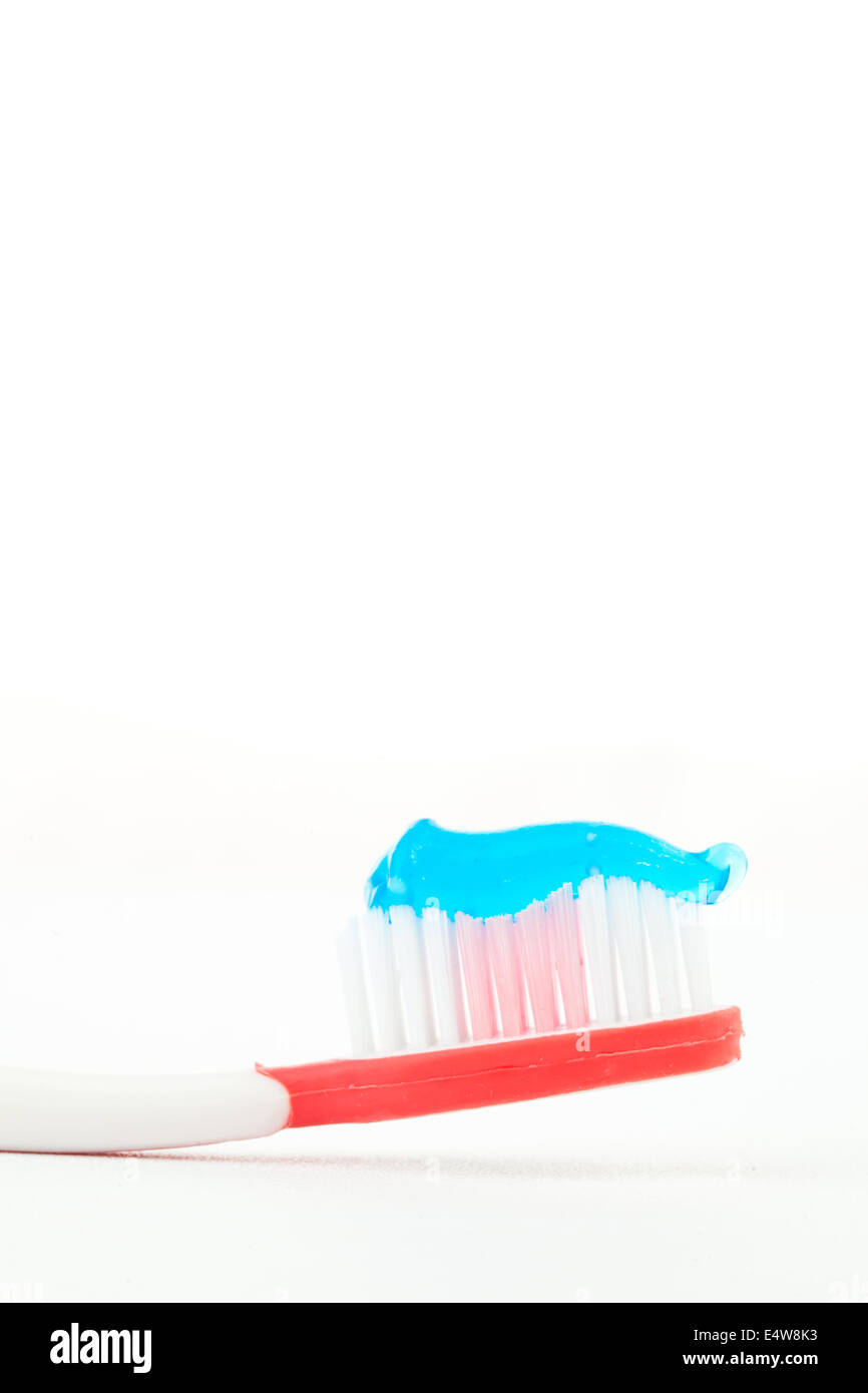 Blue toothpaste on a red toothbrush Stock Photo - Alamy