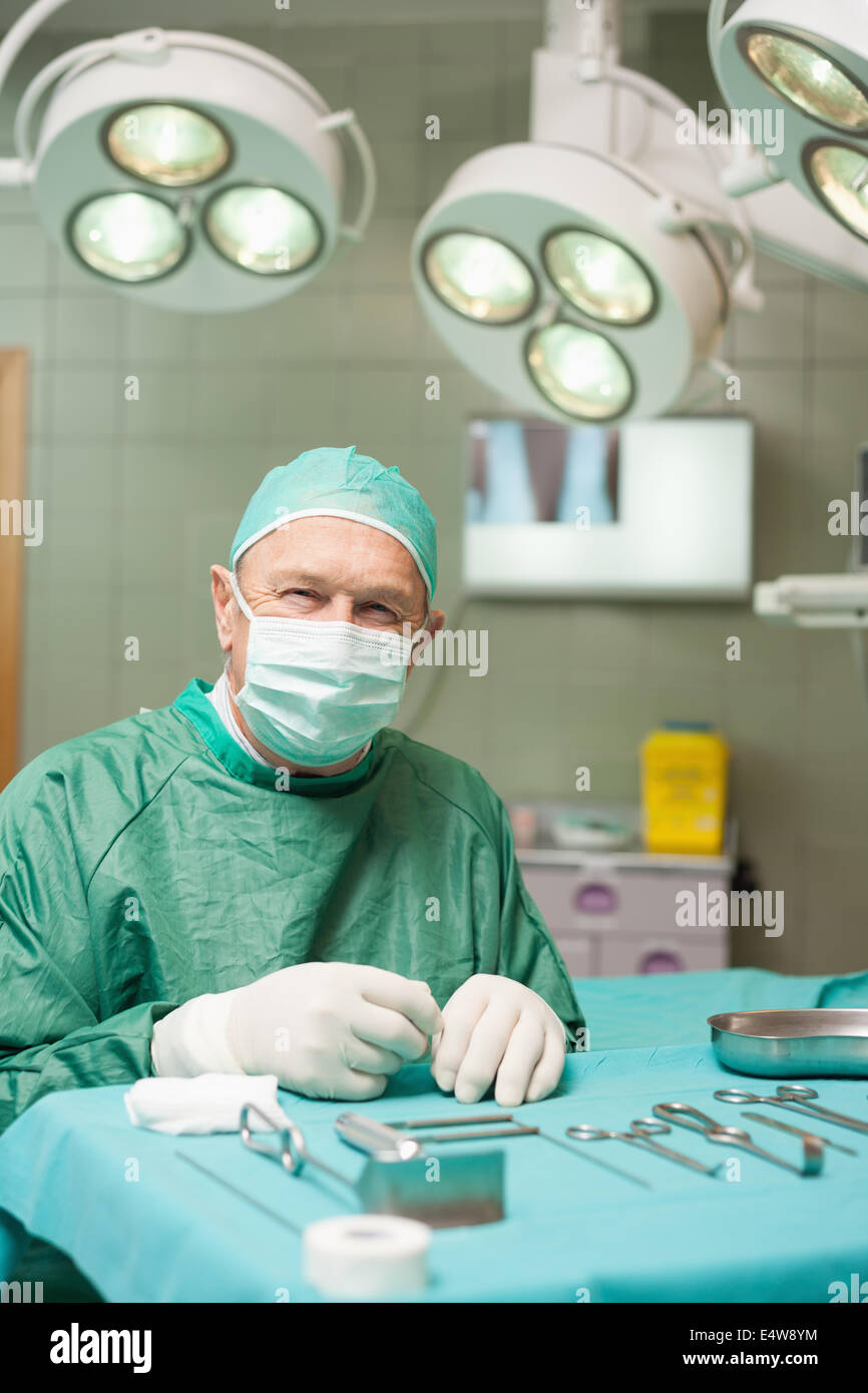 Surgeon sitting in front of surgical tools Stock Photo - Alamy