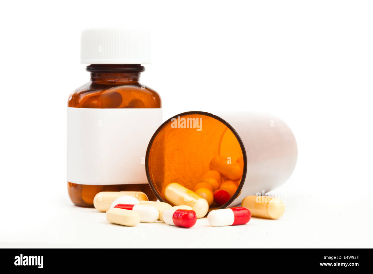 Glass bottle of capsules knocked over Stock Photo - Alamy