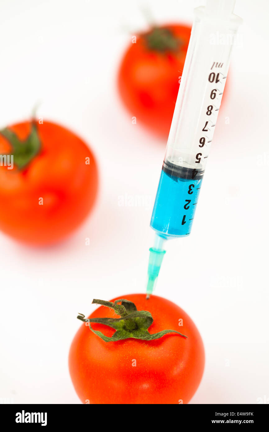 Syringe injecting blue liquid Stock Photo - Alamy