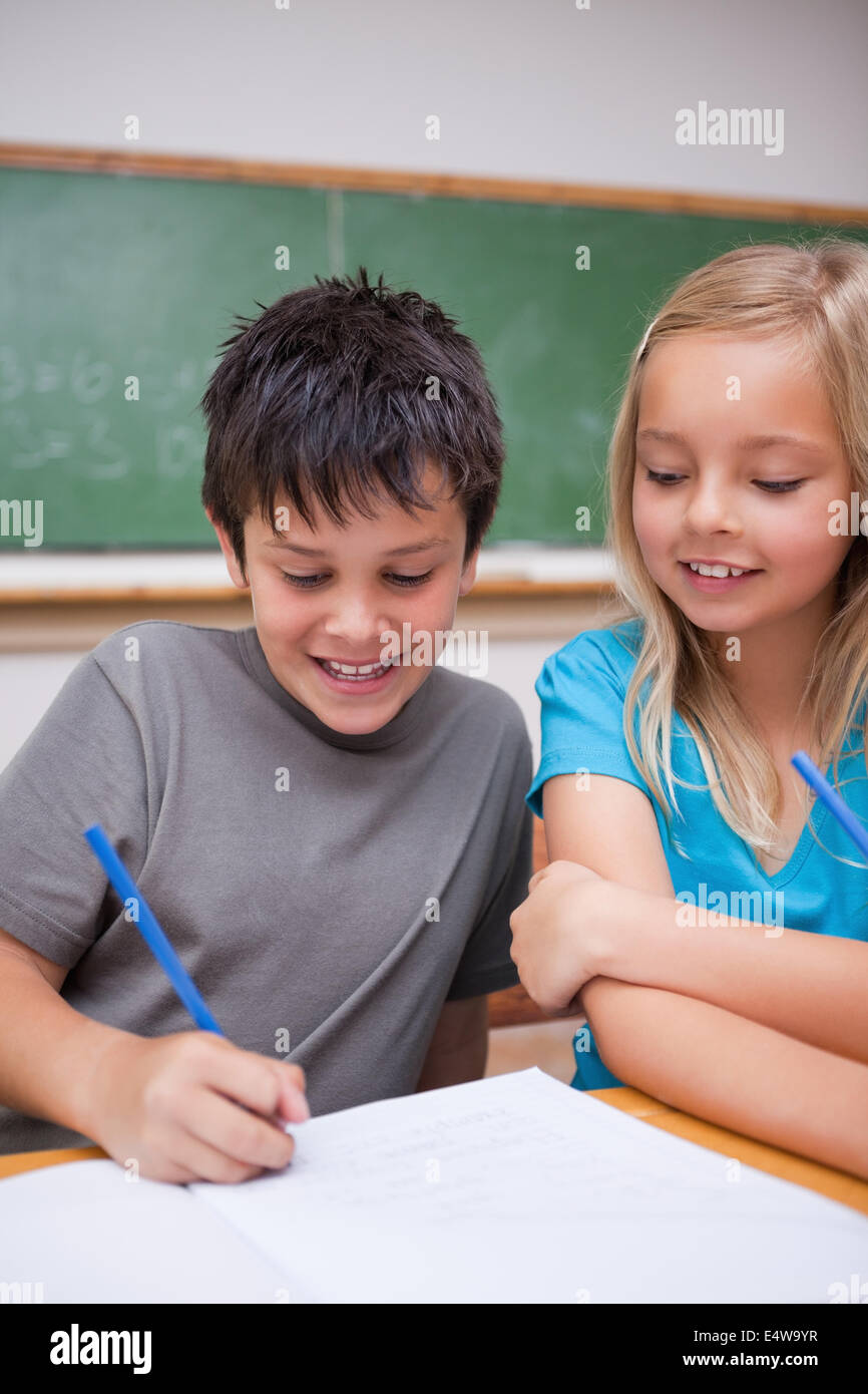 Portrait of happy pupils working together Stock Photo - Alamy