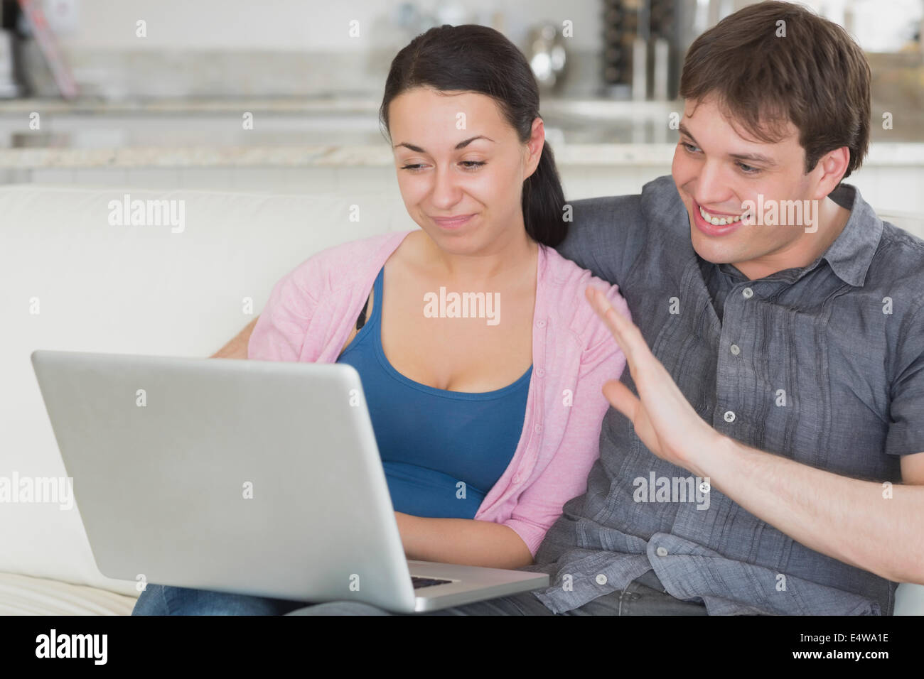 Two people using the laptop Stock Photo - Alamy