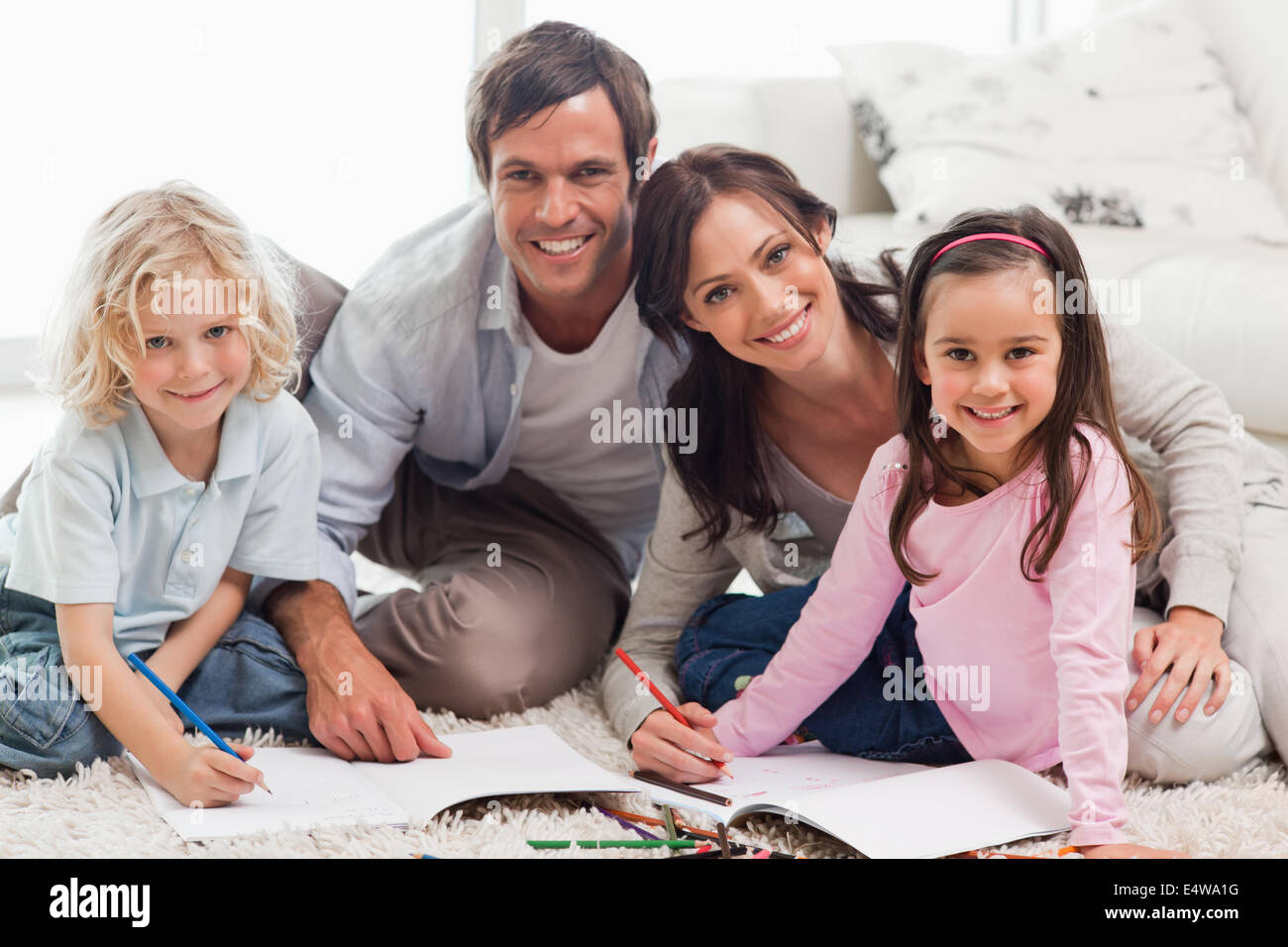 Charming family drawing together Stock Photo - Alamy