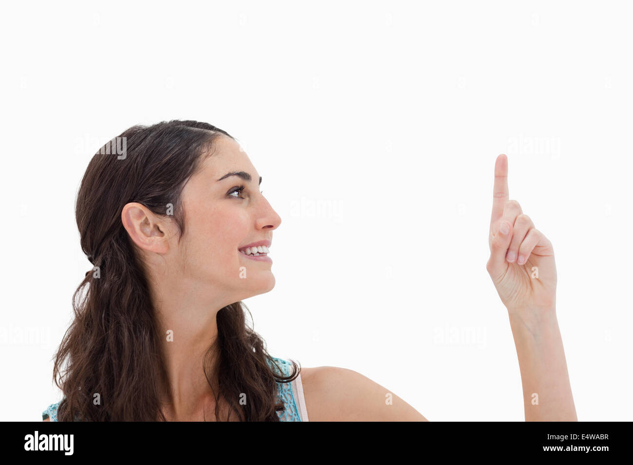 Young woman pointing at a copy space Stock Photo - Alamy