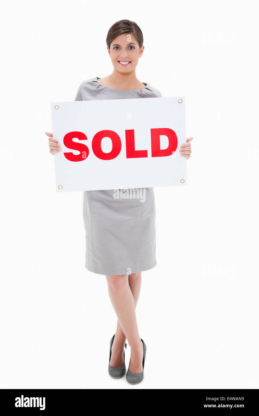 Woman holding sold sign Stock Photo - Alamy
