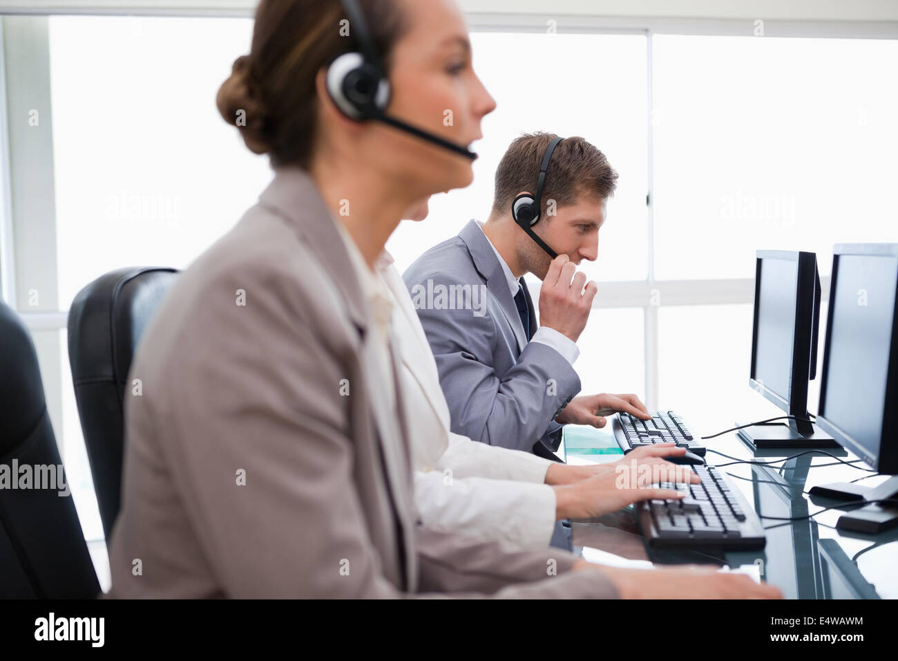 Side view of call center agents Stock Photo - Alamy