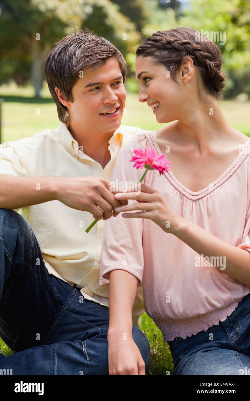Man giving a flower to a woman Stock Photo - Alamy