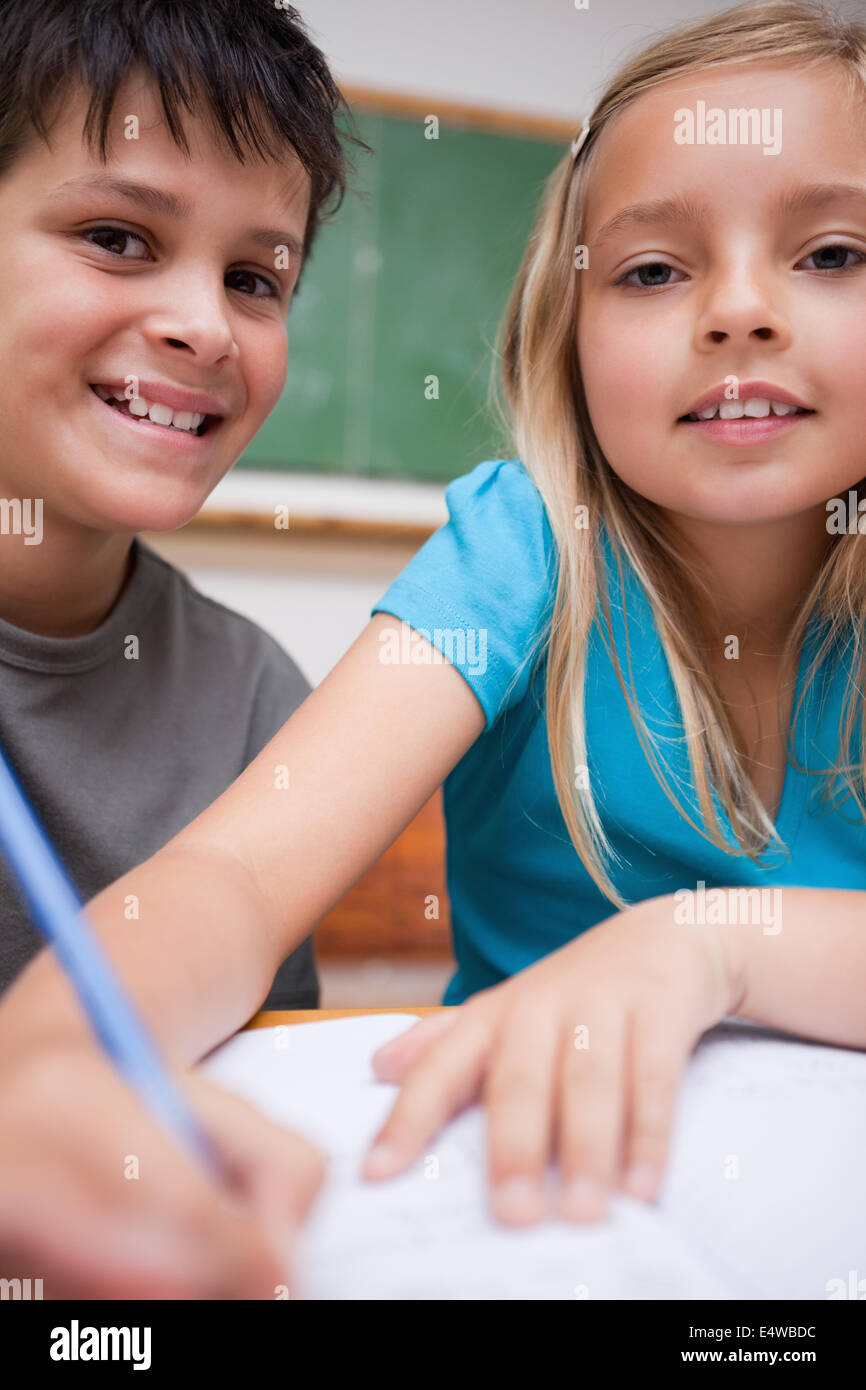 Portrait of two children writing Stock Photo - Alamy