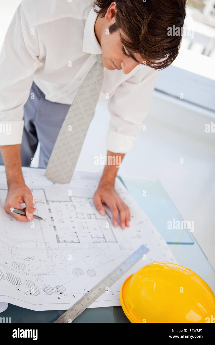 Man working hard on blueprints for work Stock Photo - Alamy