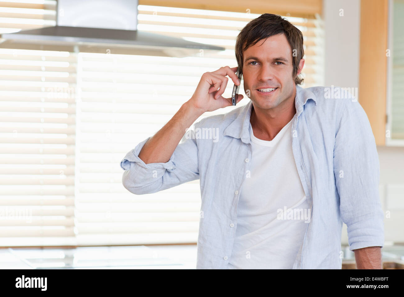Happy man making a phone call Stock Photo - Alamy