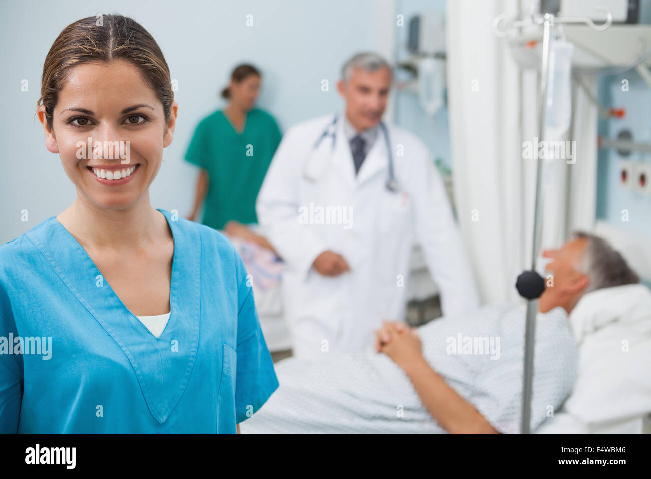 Happy nurse in hospital room Stock Photo - Alamy