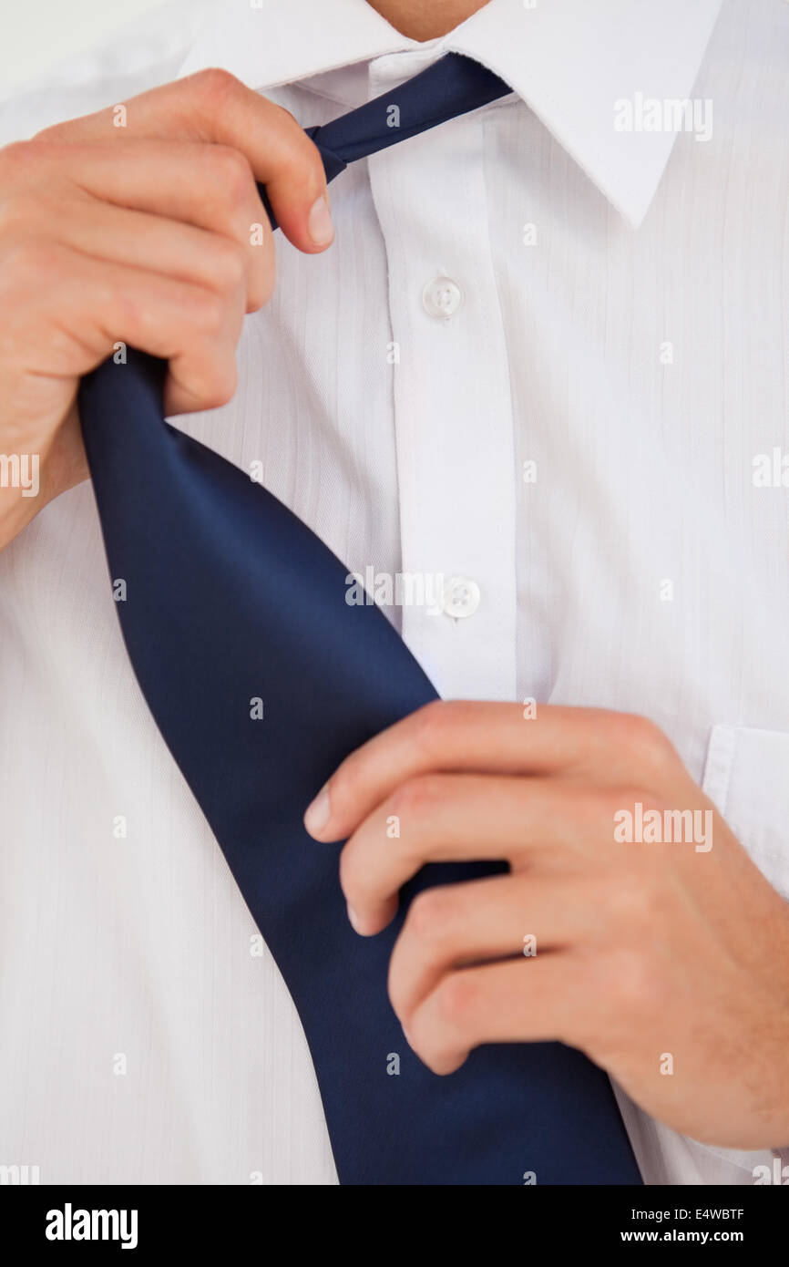 Man undoing his tie Stock Photo - Alamy