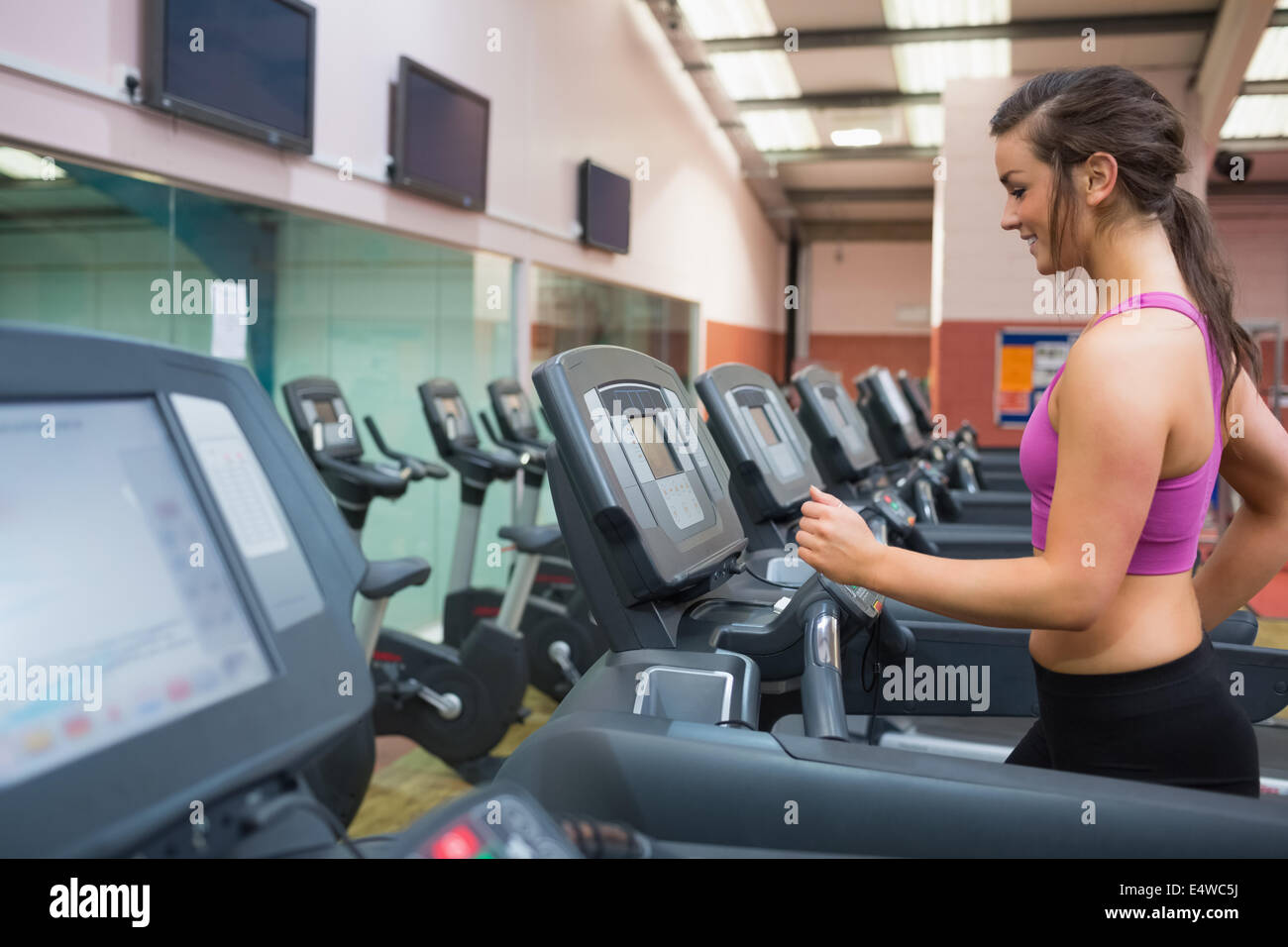 Woman running on a treadmill in a gym Stock Photo - Alamy