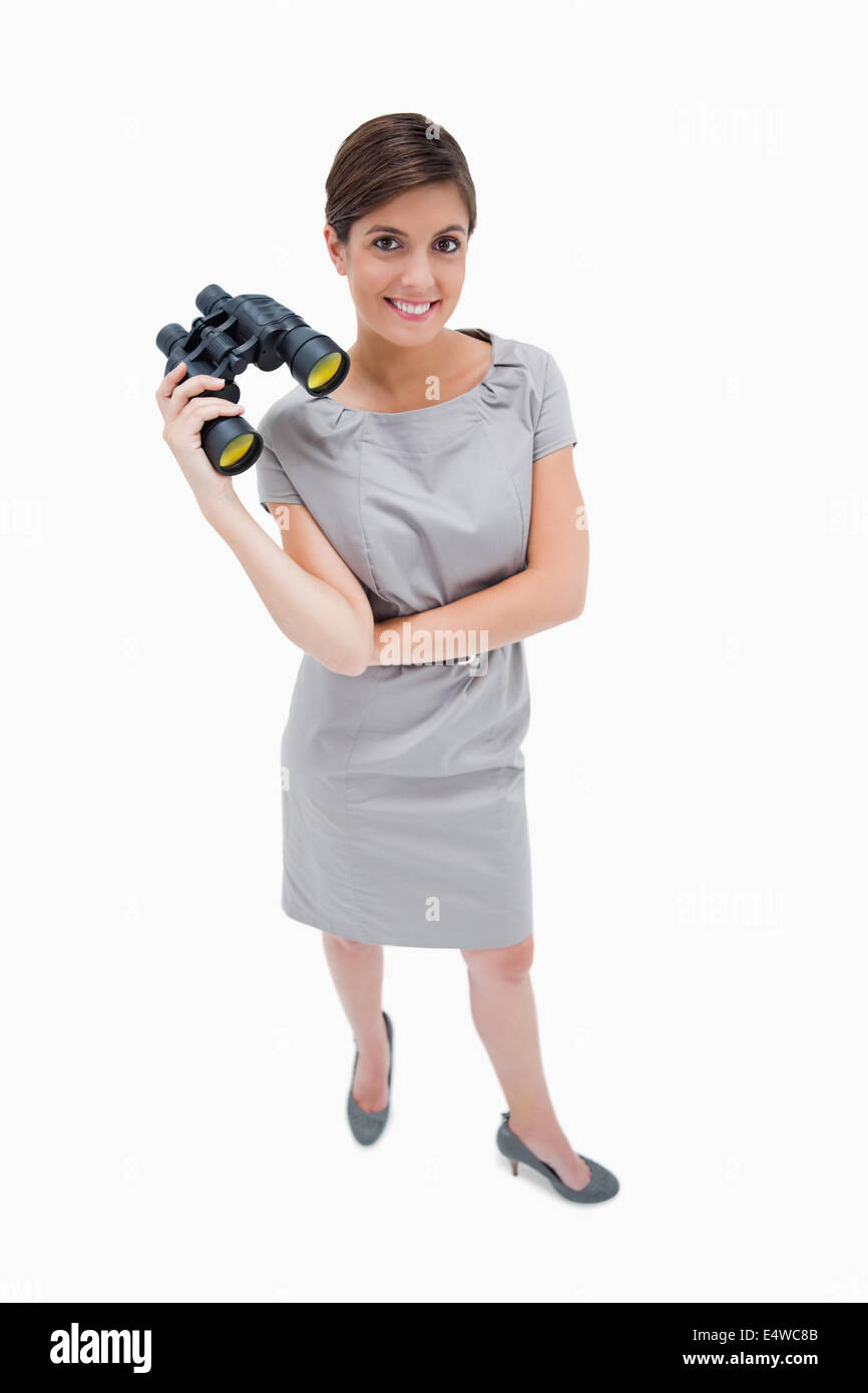 Woman standing with binoculars Stock Photo - Alamy