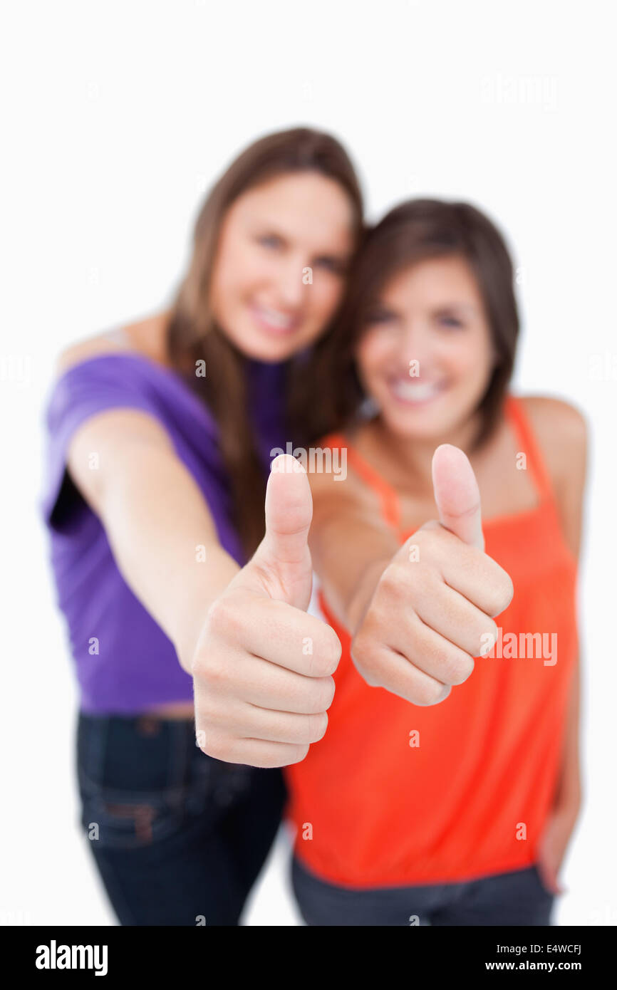 Two thumbs up being showed by teenagers Stock Photo - Alamy