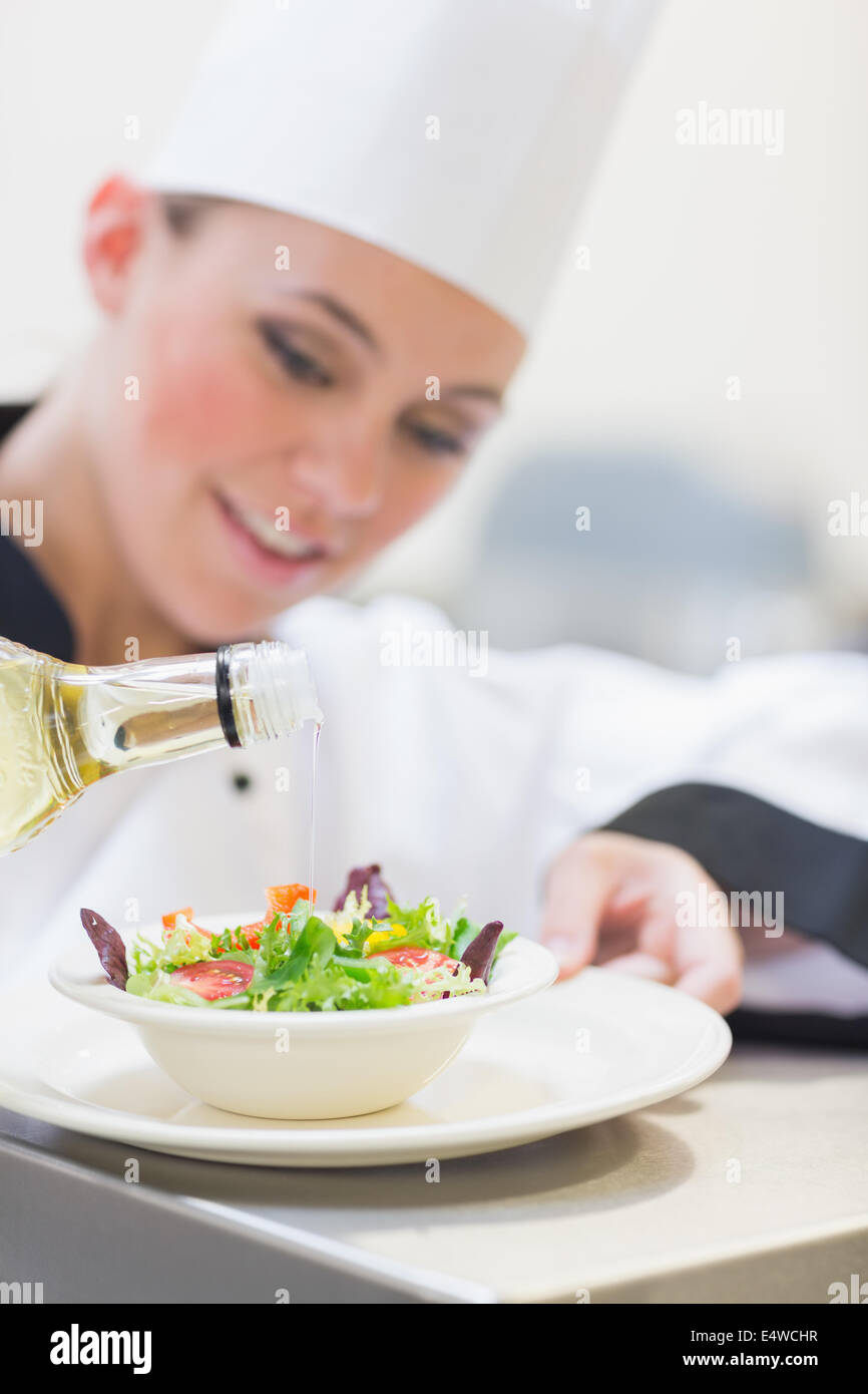 Chef pouring olive oil over salad Stock Photo - Alamy