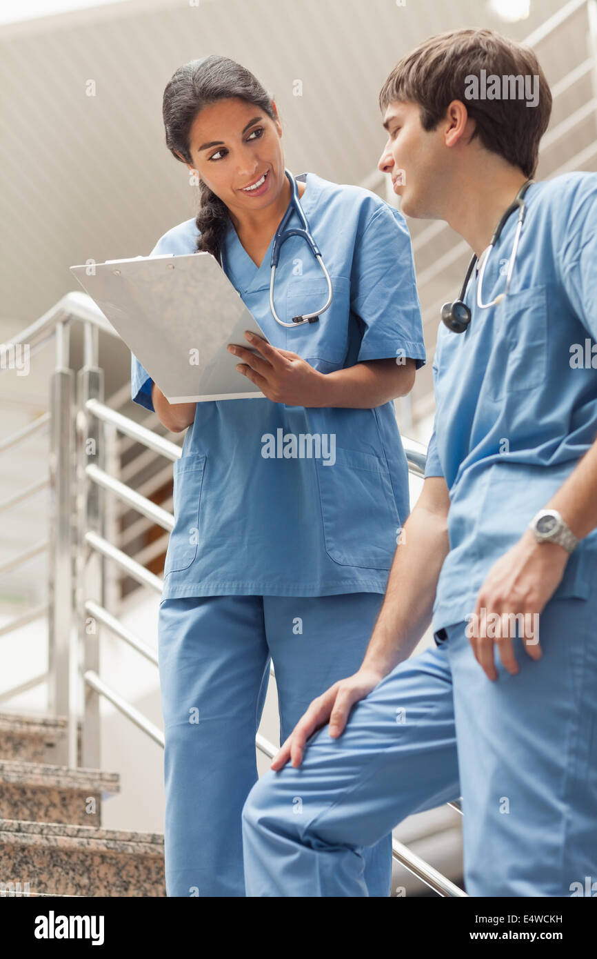 Nurse holding a notepad on stairs Stock Photo - Alamy