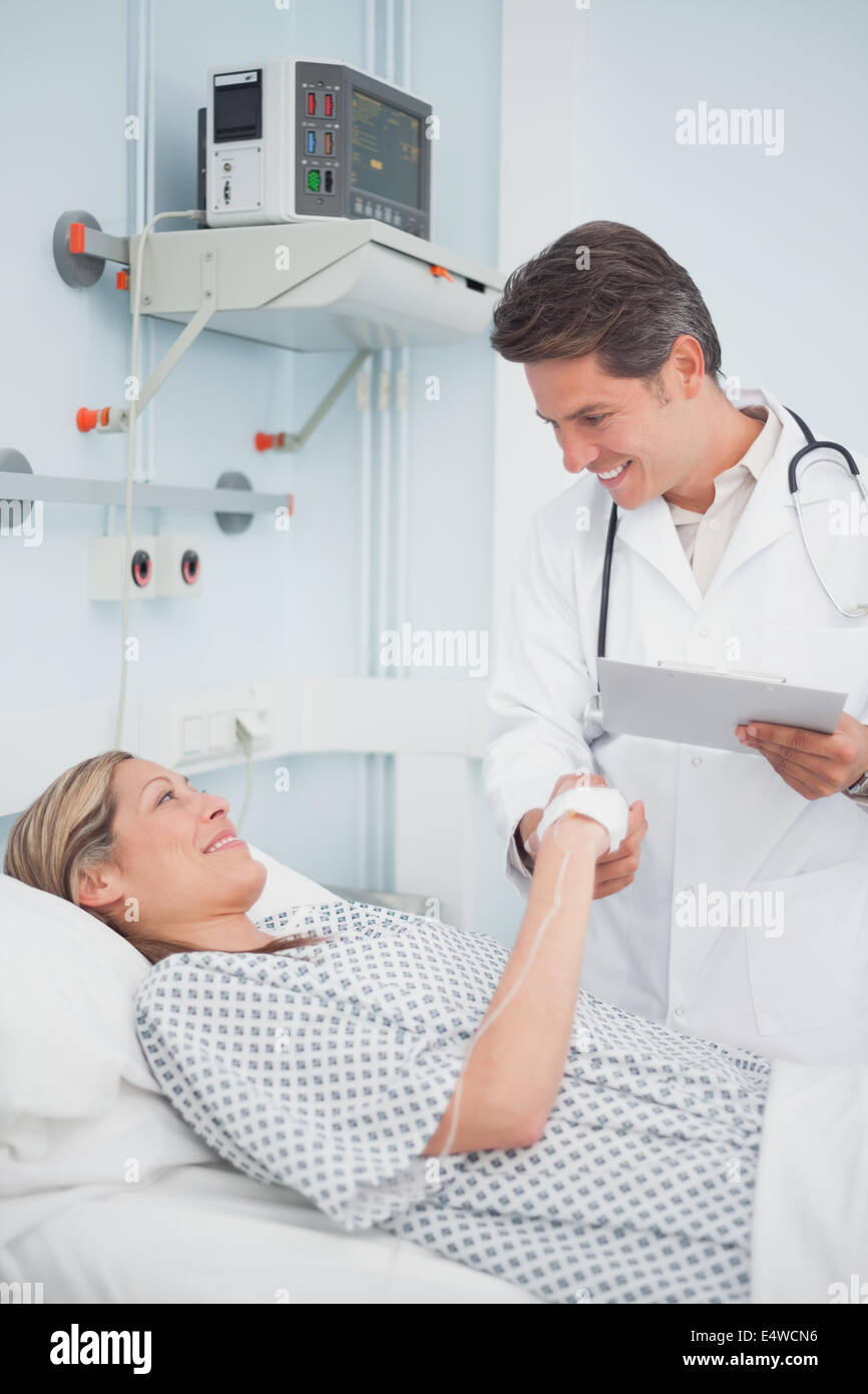 Doctor smiling to his patient Stock Photo - Alamy