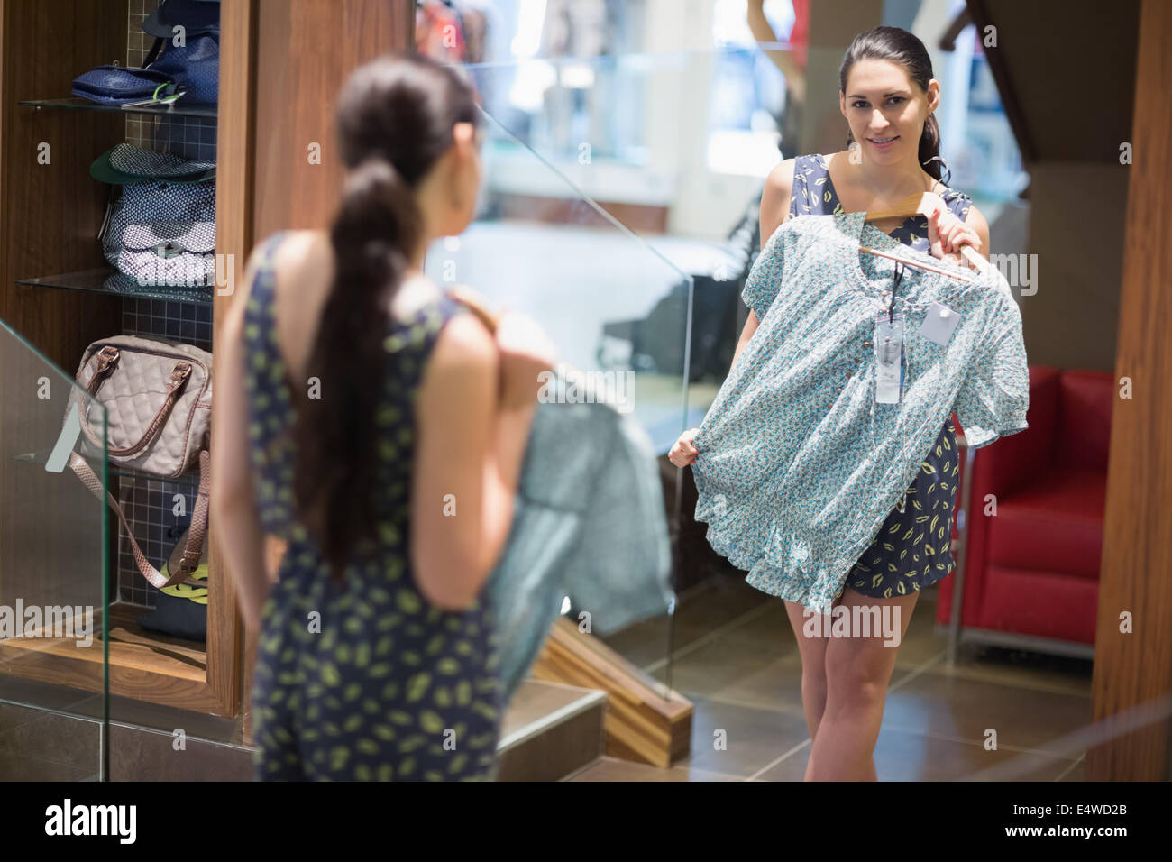 Woman smiling in the mirror Stock Photo - Alamy