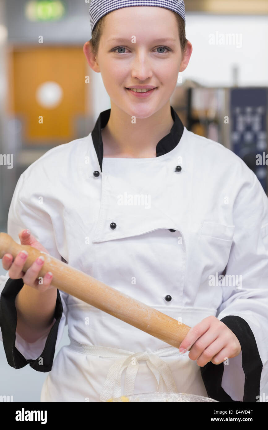 Smiling chef holding rolling pin Stock Photo - Alamy