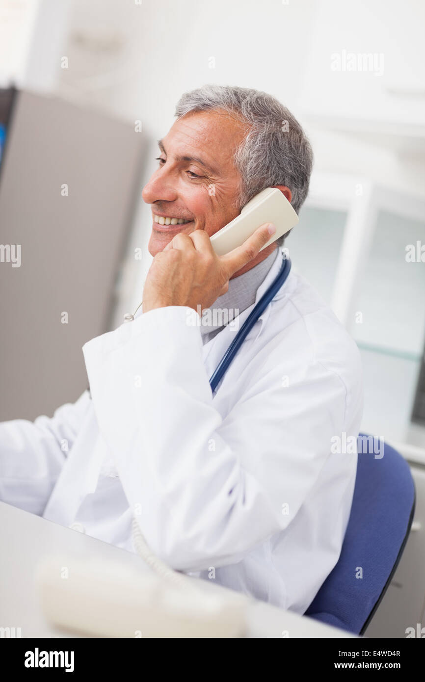 Smiling doctor calling Stock Photo - Alamy
