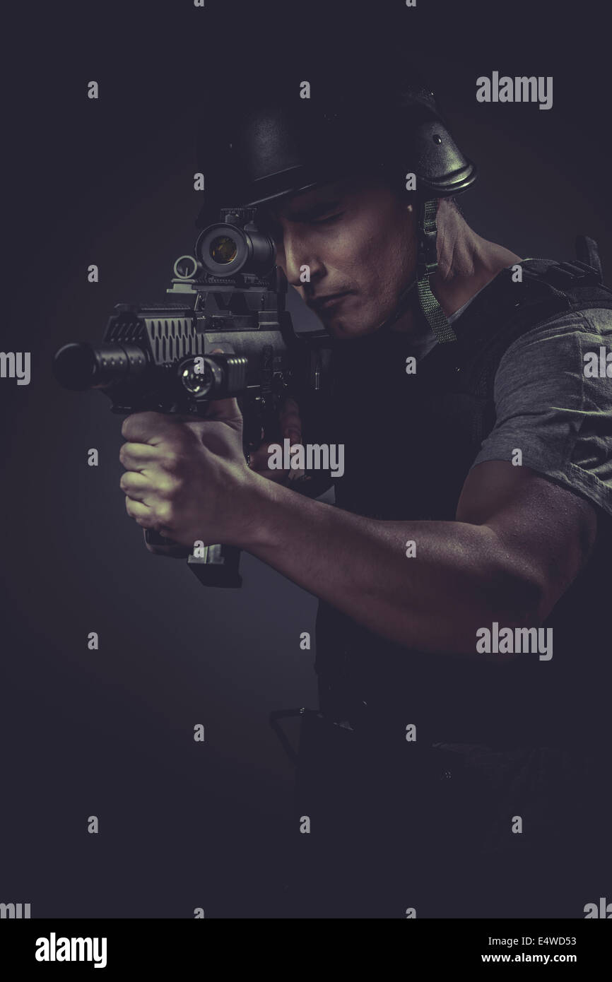 recreation player wearing protective helmet aiming pistol ,black armor ...